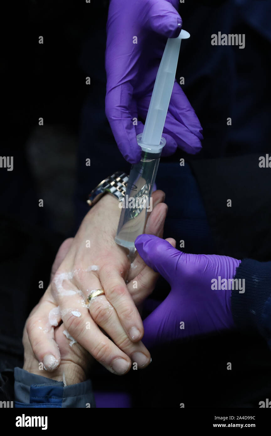 Police attempt to free protesters who have glued each other's hands ...