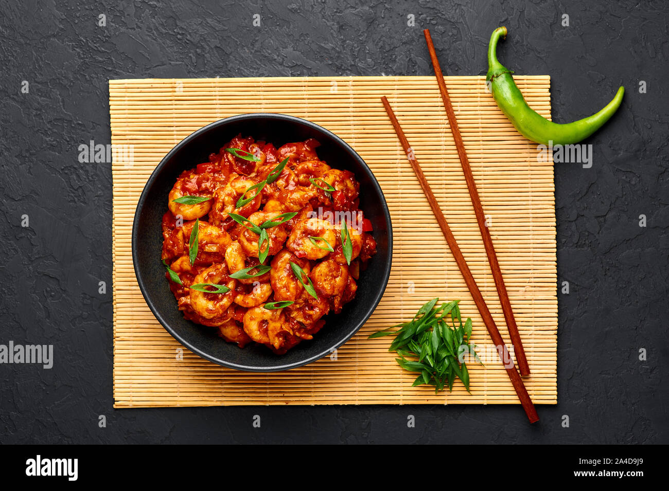 Schezwan Prawns in black bowl at dark slate background. Schezwan Prawns ...
