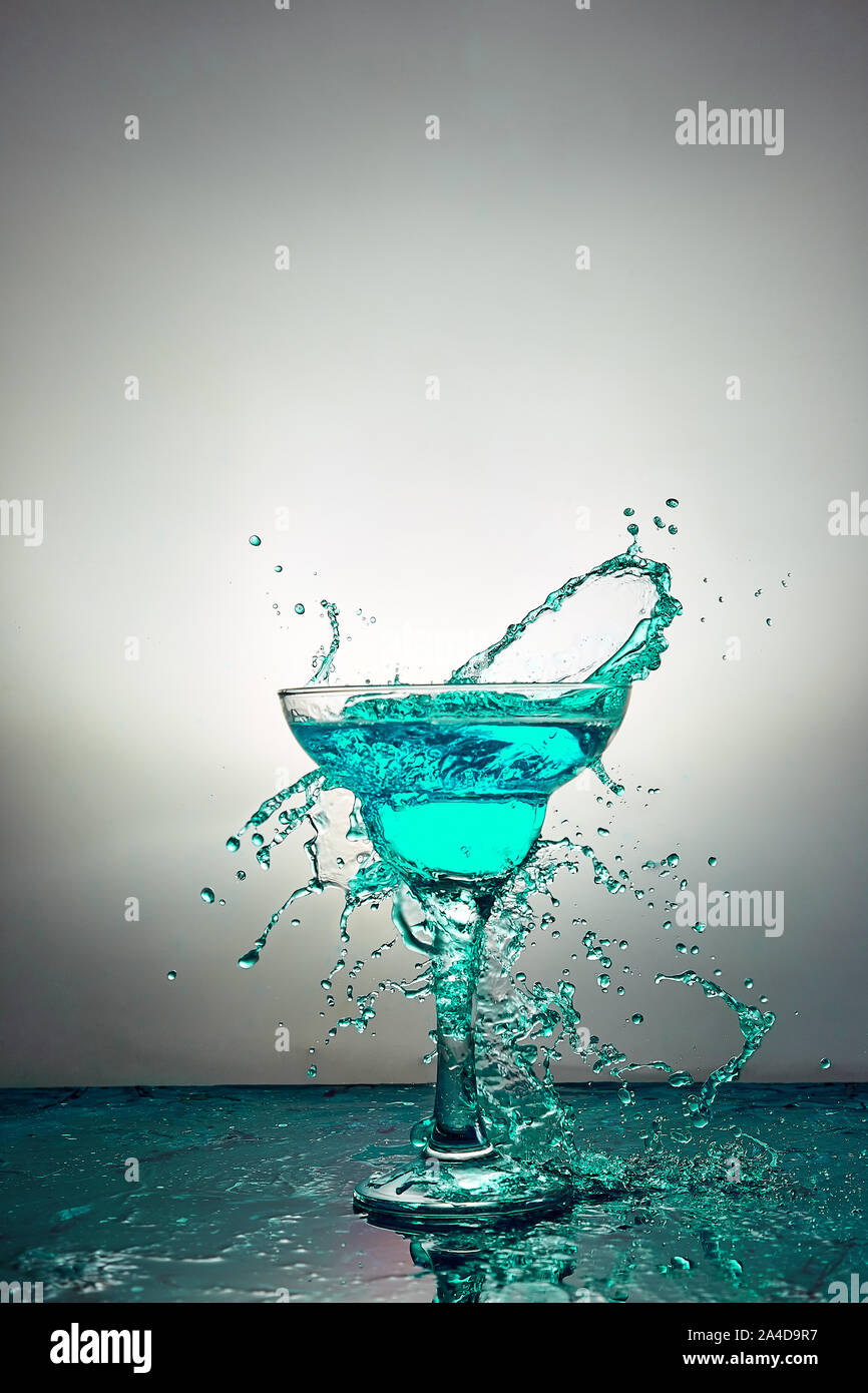 Glass with blue champagne or alcohol drink cocktail, martini glasses ...