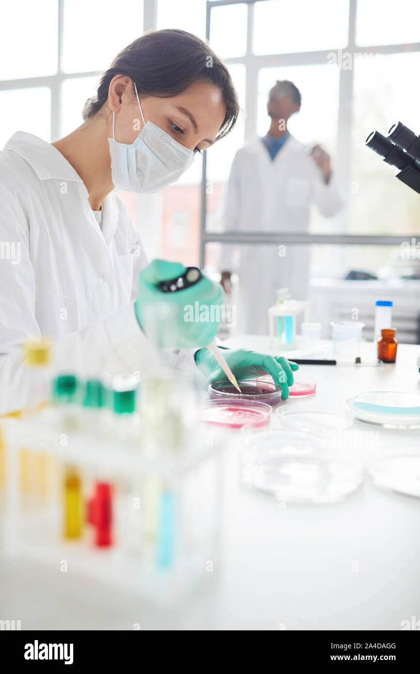 Side view portrait of young woman working in medical laboratory ...