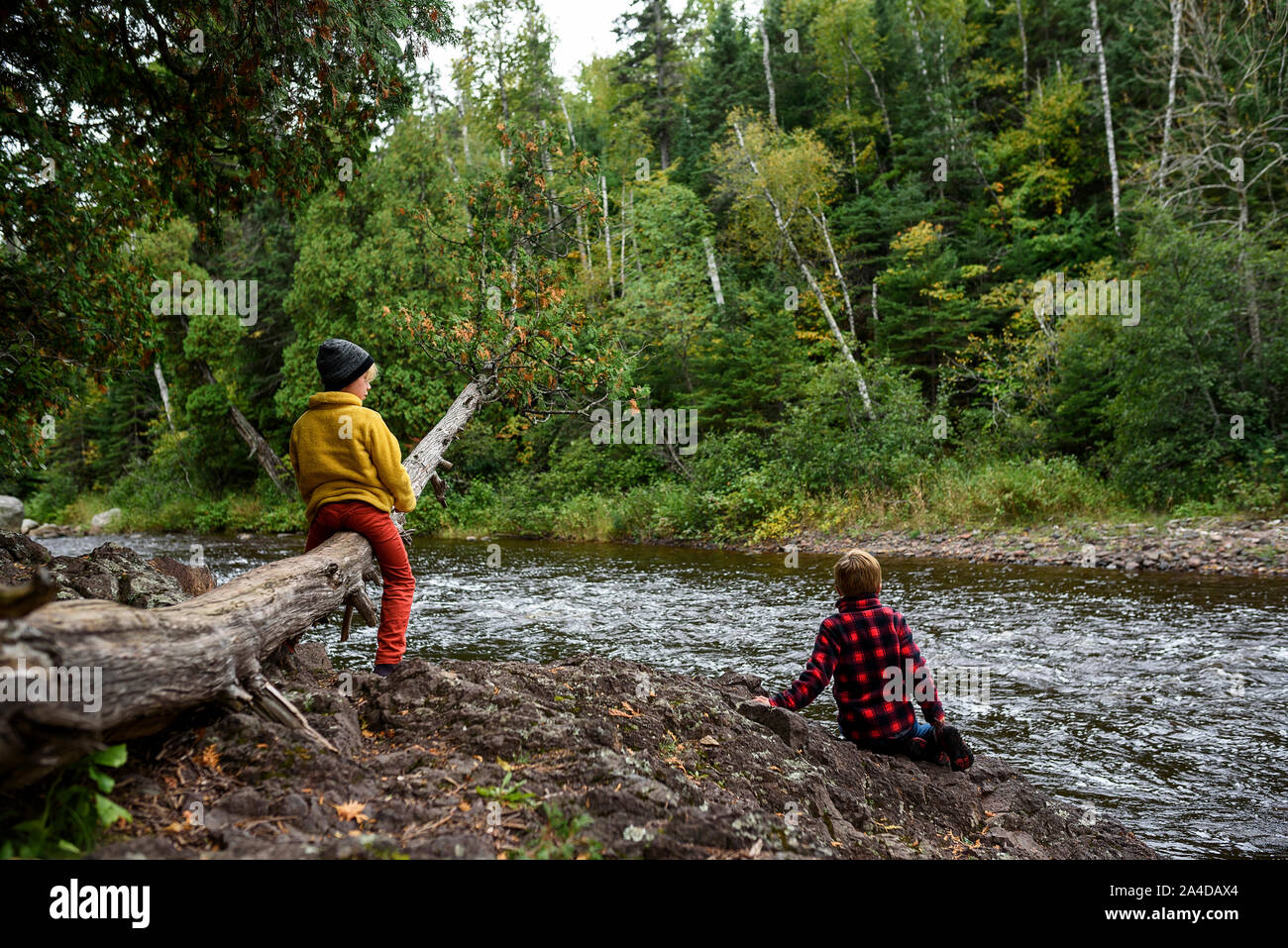 Two boys playing next to a river, United States Stock Photo - Alamy
