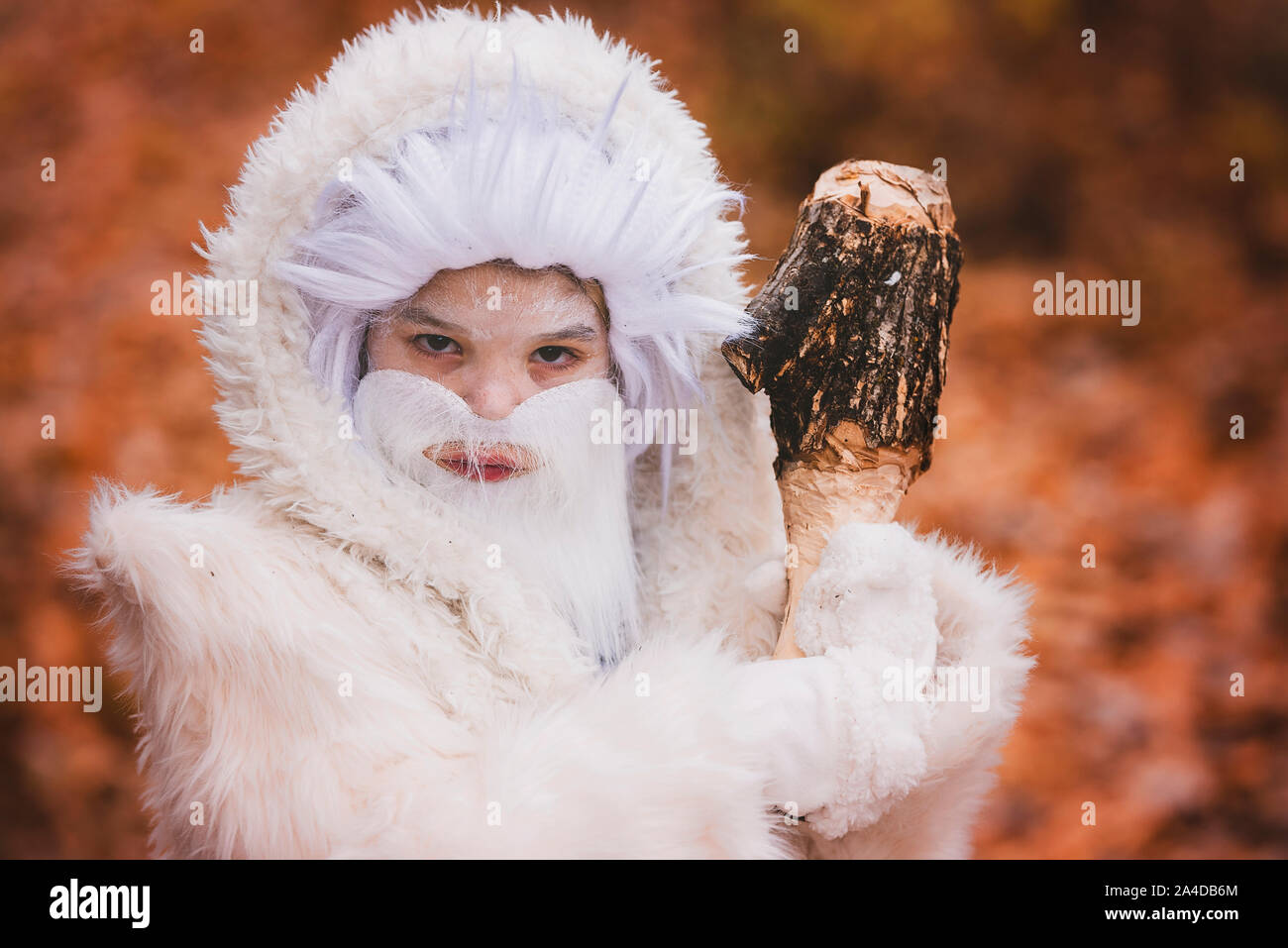 Boy standing in forest dressed as a white yeti for Halloween, United ...