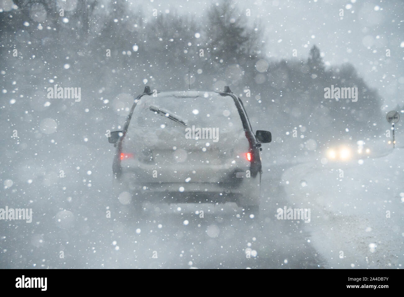 he car is driving on a winter road in a blizzard Stock Photo - Alamy