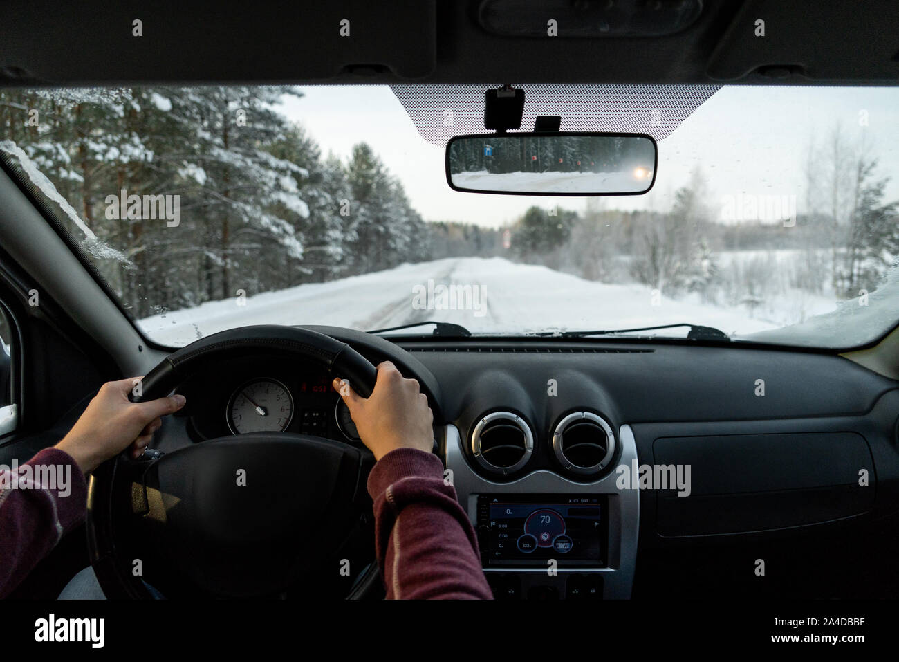 A man drives a car on a winter road Stock Photo - Alamy