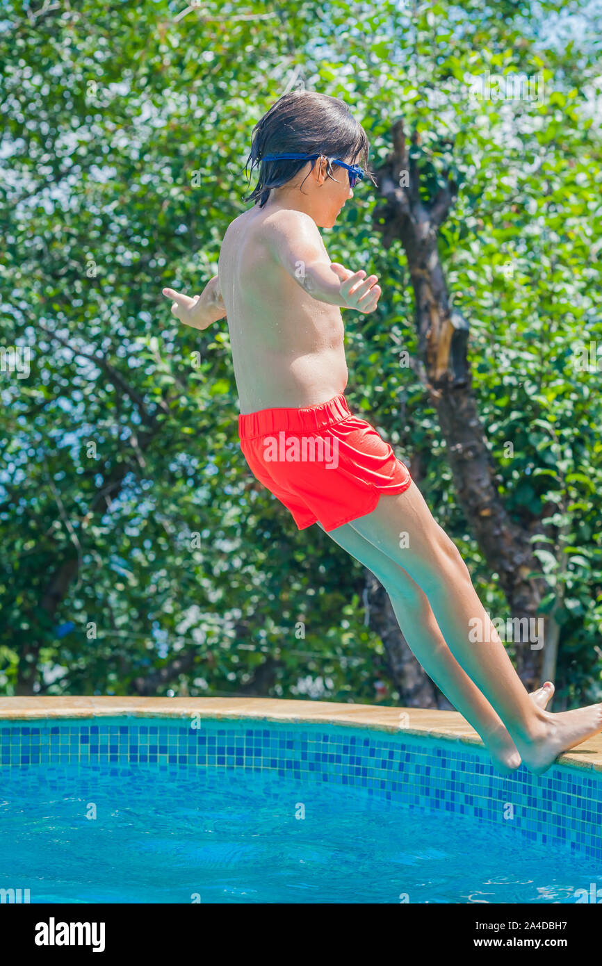 Boy jumping backwards hi-res stock photography and images - Alamy