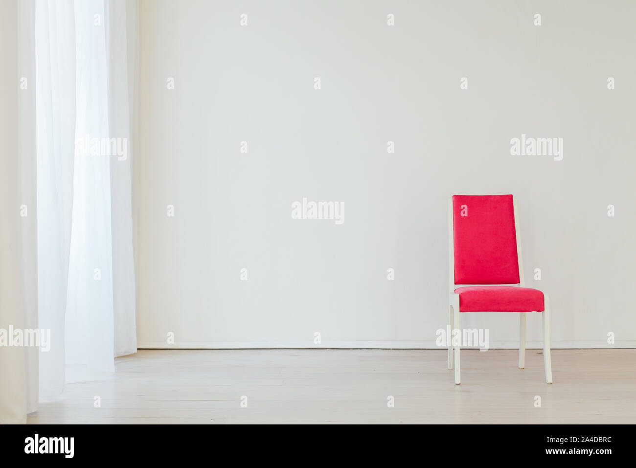 pink chair stands alone in the white room Stock Photo - Alamy