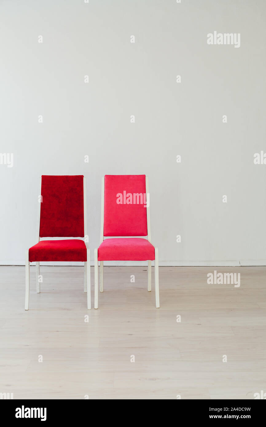 two chairs red and pink stand in the white room Stock Photo - Alamy