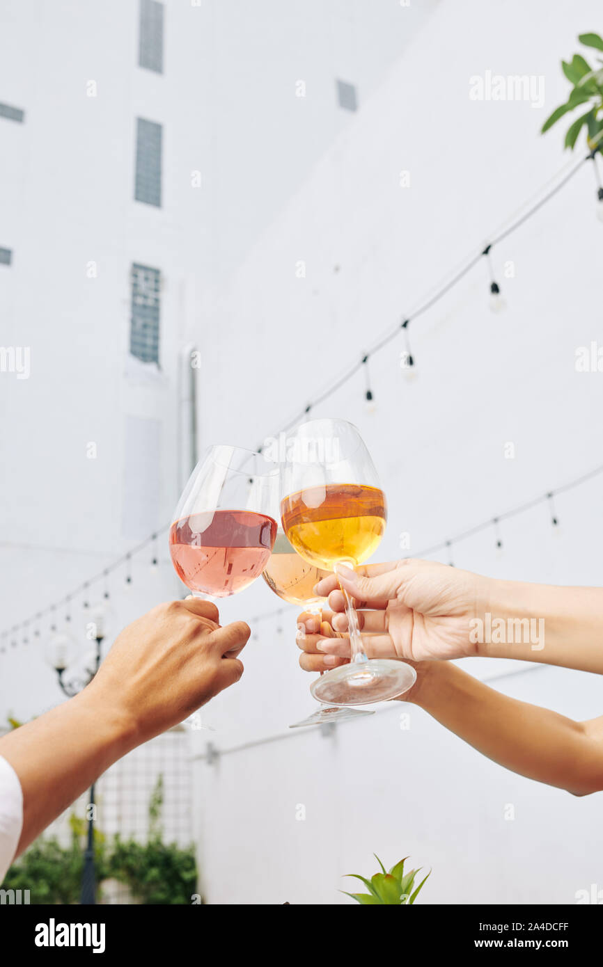 Hands of party guests toasting with glasses of rose wine Stock Photo ...