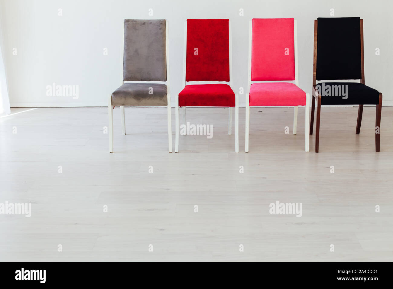 four chairs stand in an empty white room Stock Photo - Alamy