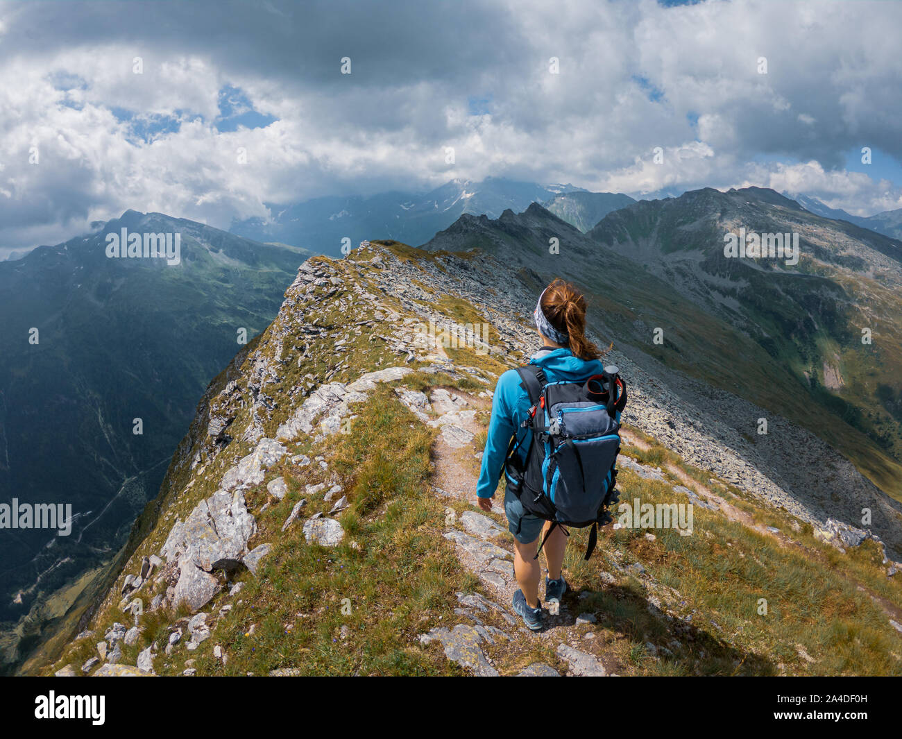 Woman hiking to the top of a mountain hi-res stock photography and ...