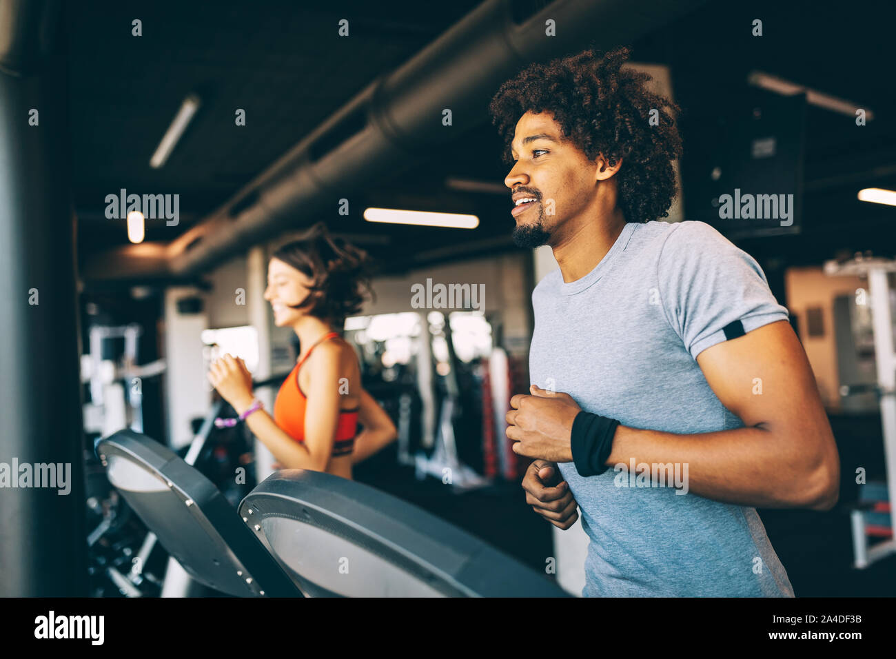 Teamwork in gym. Couple working exercise together Stock Photo - Alamy