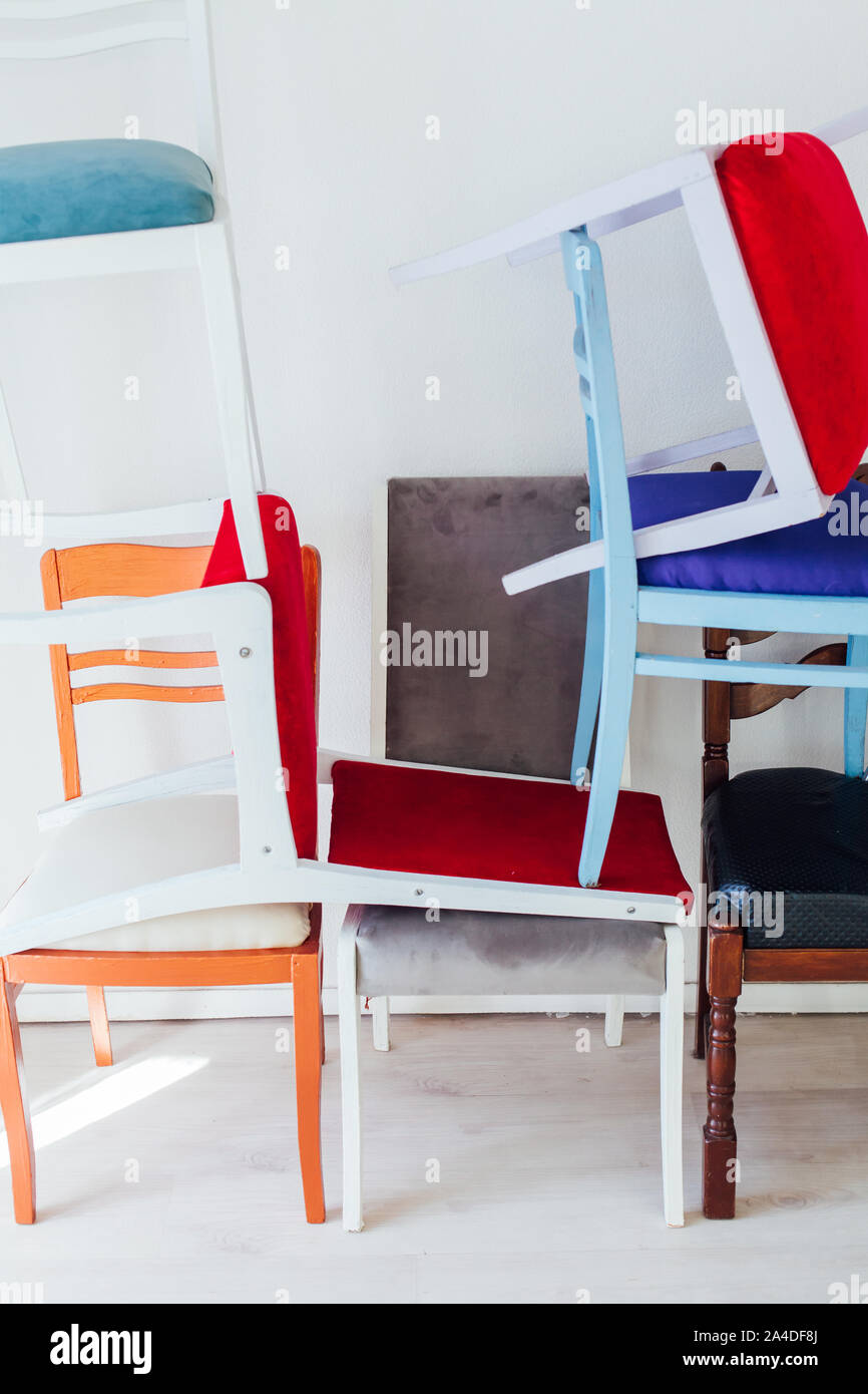 many different chairs stand in the white room Stock Photo - Alamy