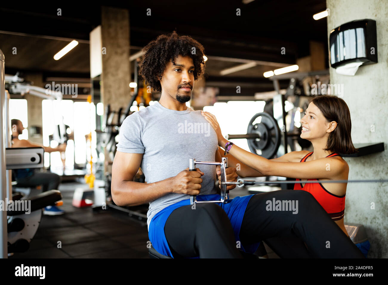 Teamwork in gym. Couple working exercise together Stock Photo - Alamy