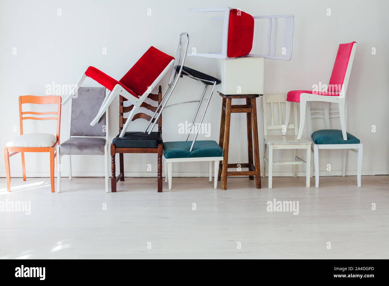 many multicolored chairs stand in the white room Stock Photo - Alamy