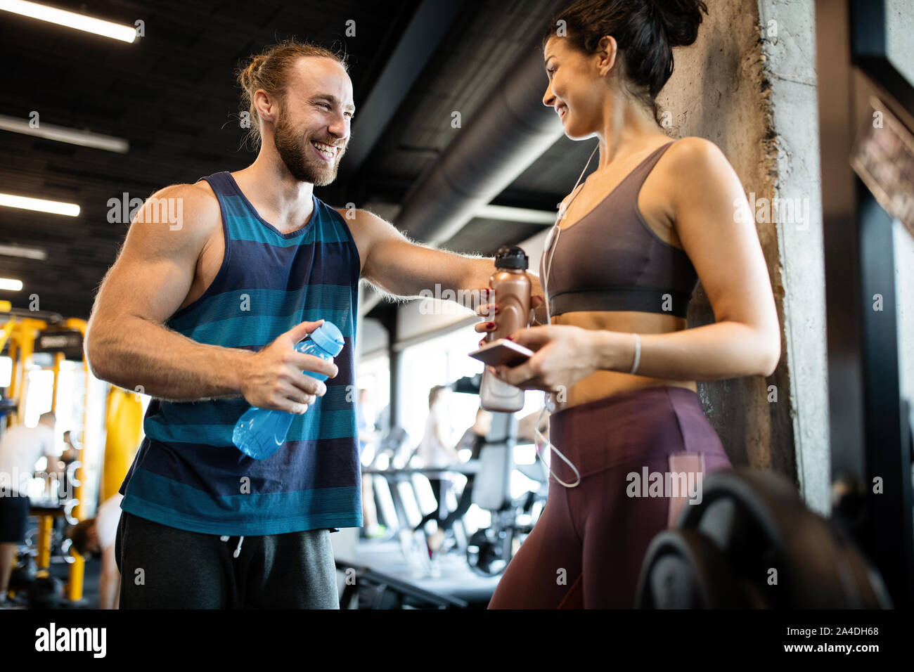 Happy friends enjoying break while chatting in the gym Stock Photo - Alamy