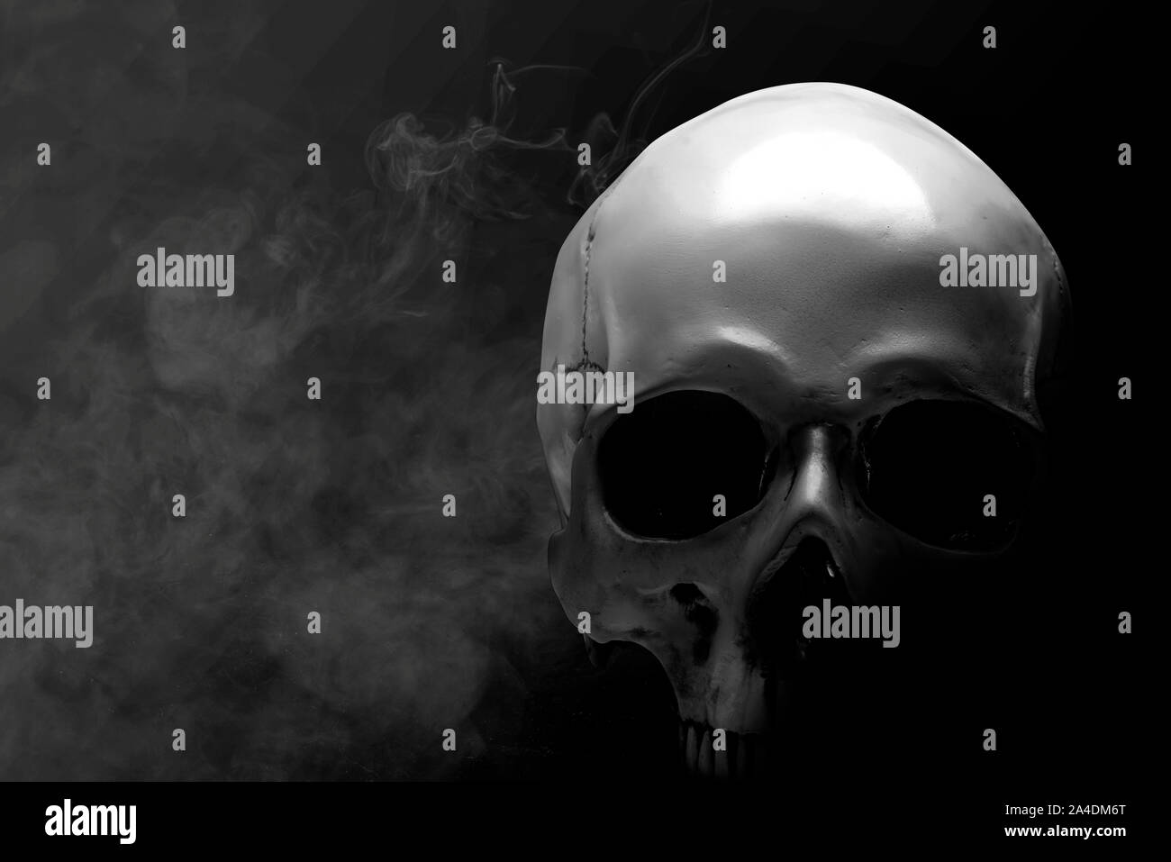 Human skull over dark smoke background Stock Photo - Alamy