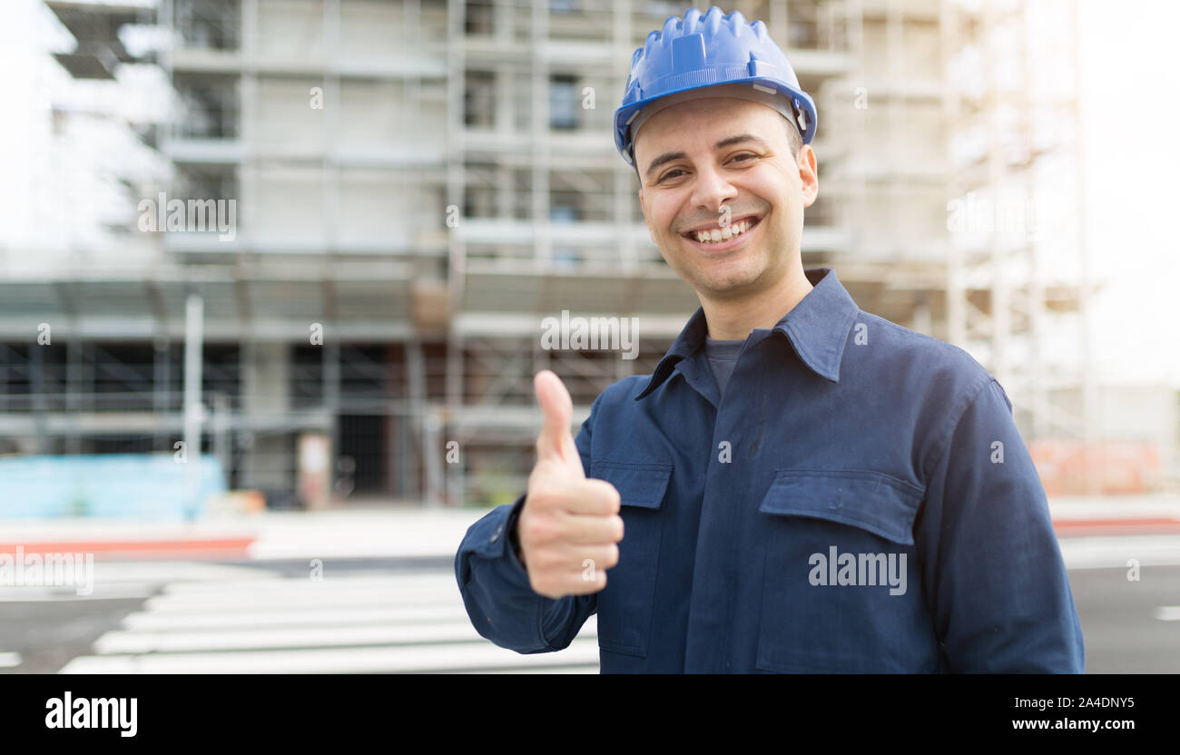 Site manager giving thumbs up in front of a construction site Stock ...