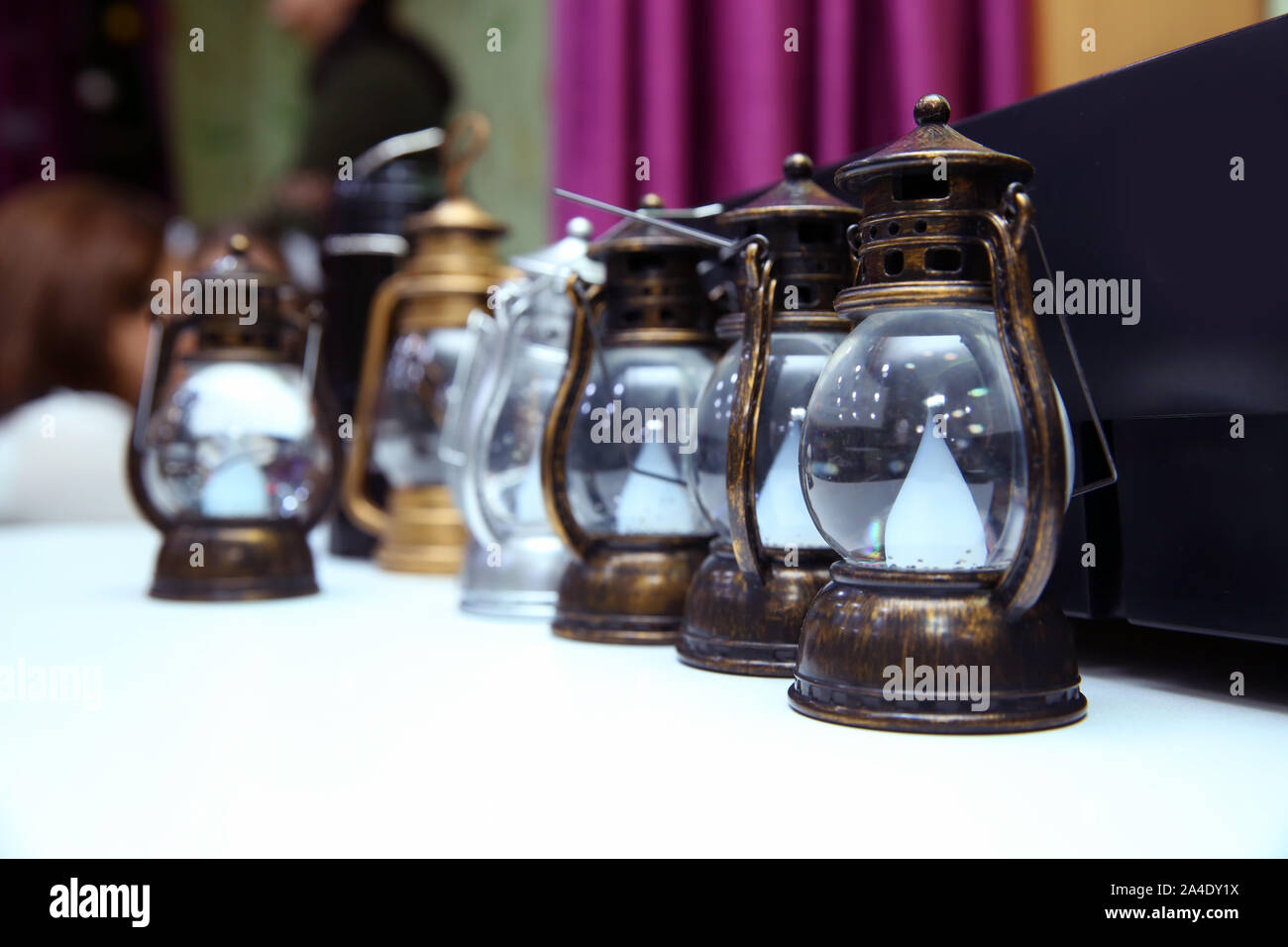 Vintage small old kerosene lamps on a wooden background . Old small oil ...