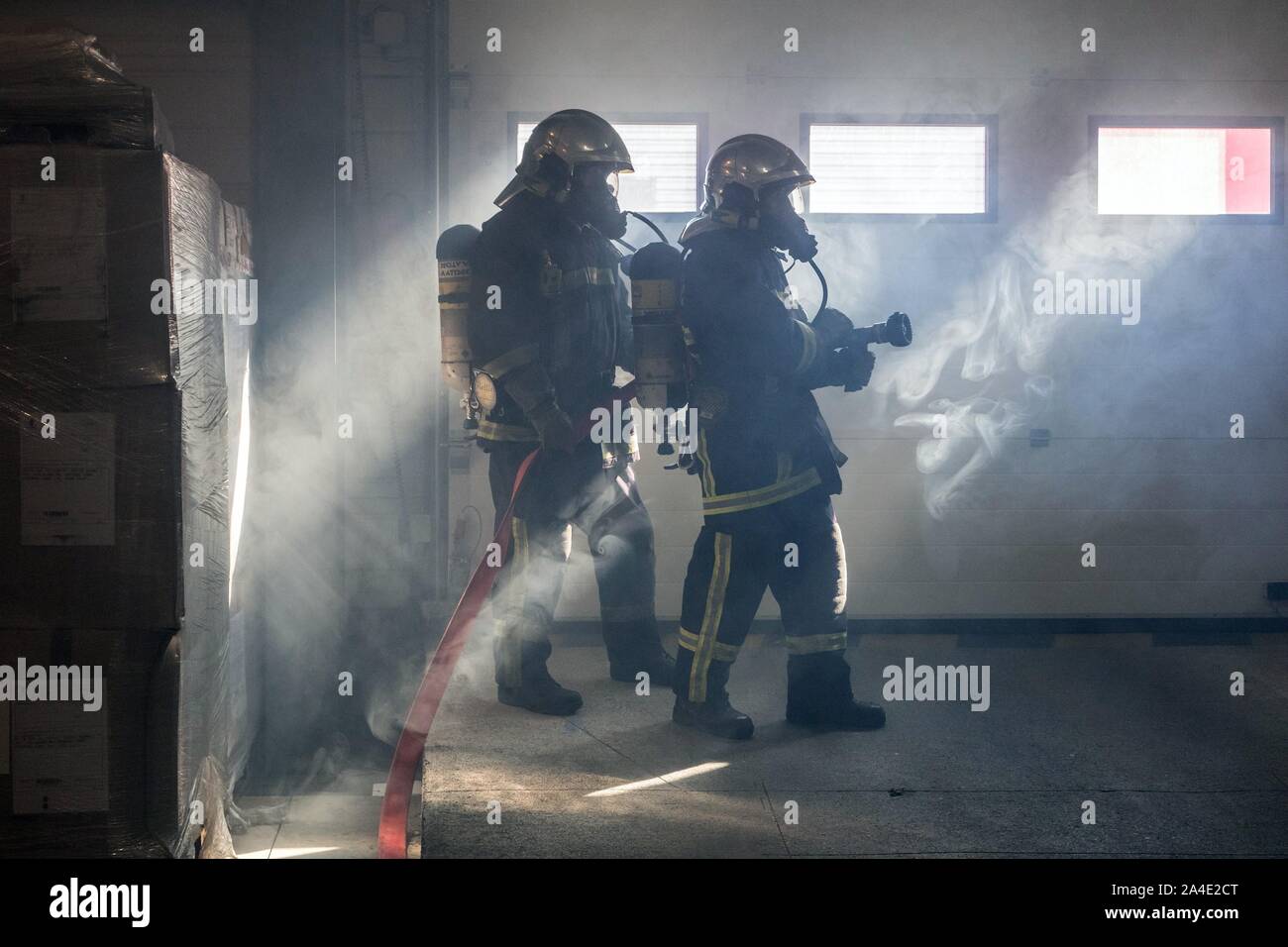 Two firefighters on hose hi-res stock photography and images - Alamy