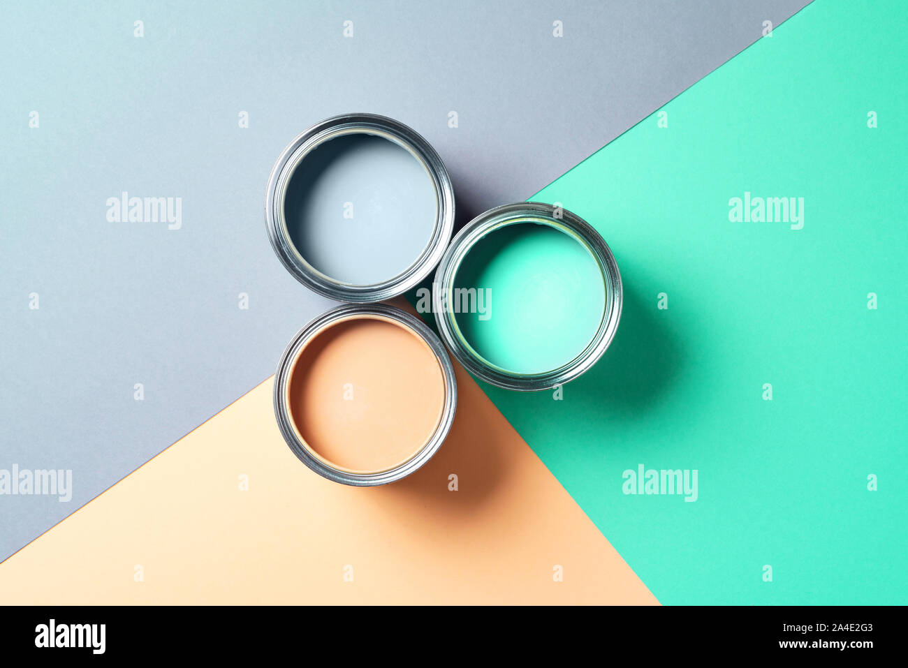 Open cans of paint on bright multicolored background. Top view. Copy ...