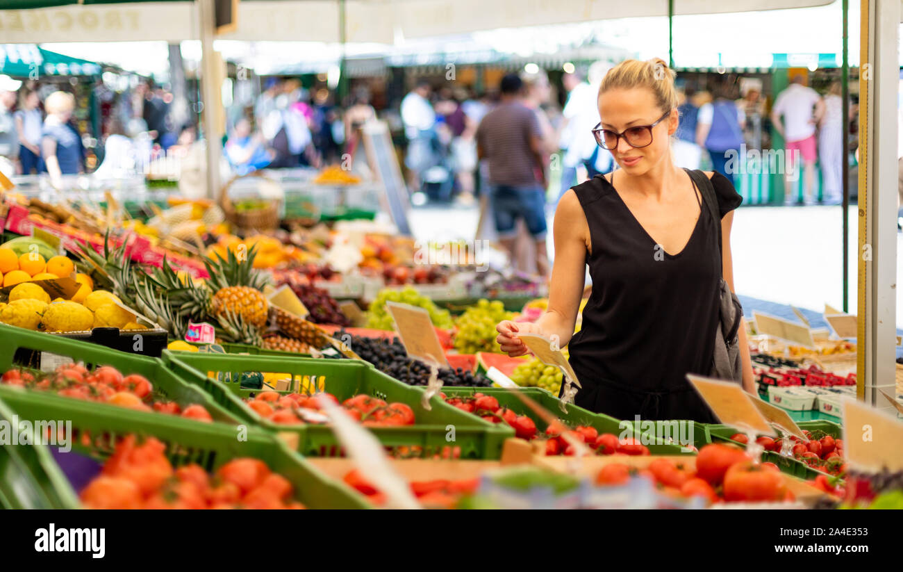 Woman buying fruits and vegetables at local food market. Market stall ...