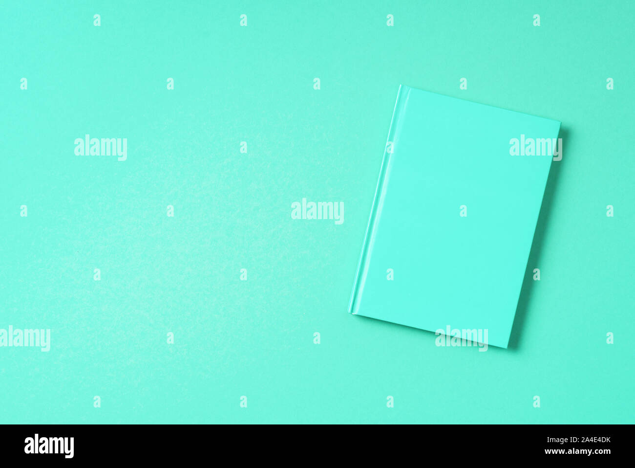 Closed mint notebook on trendy green background. Top view, copy space ...