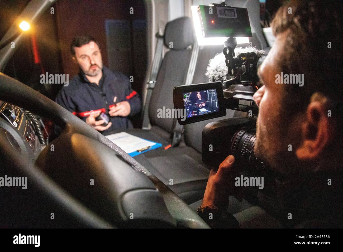 INTERVIEW OF A FIREFIGHTER DURING THE FILMING OF A TELEVISION ...