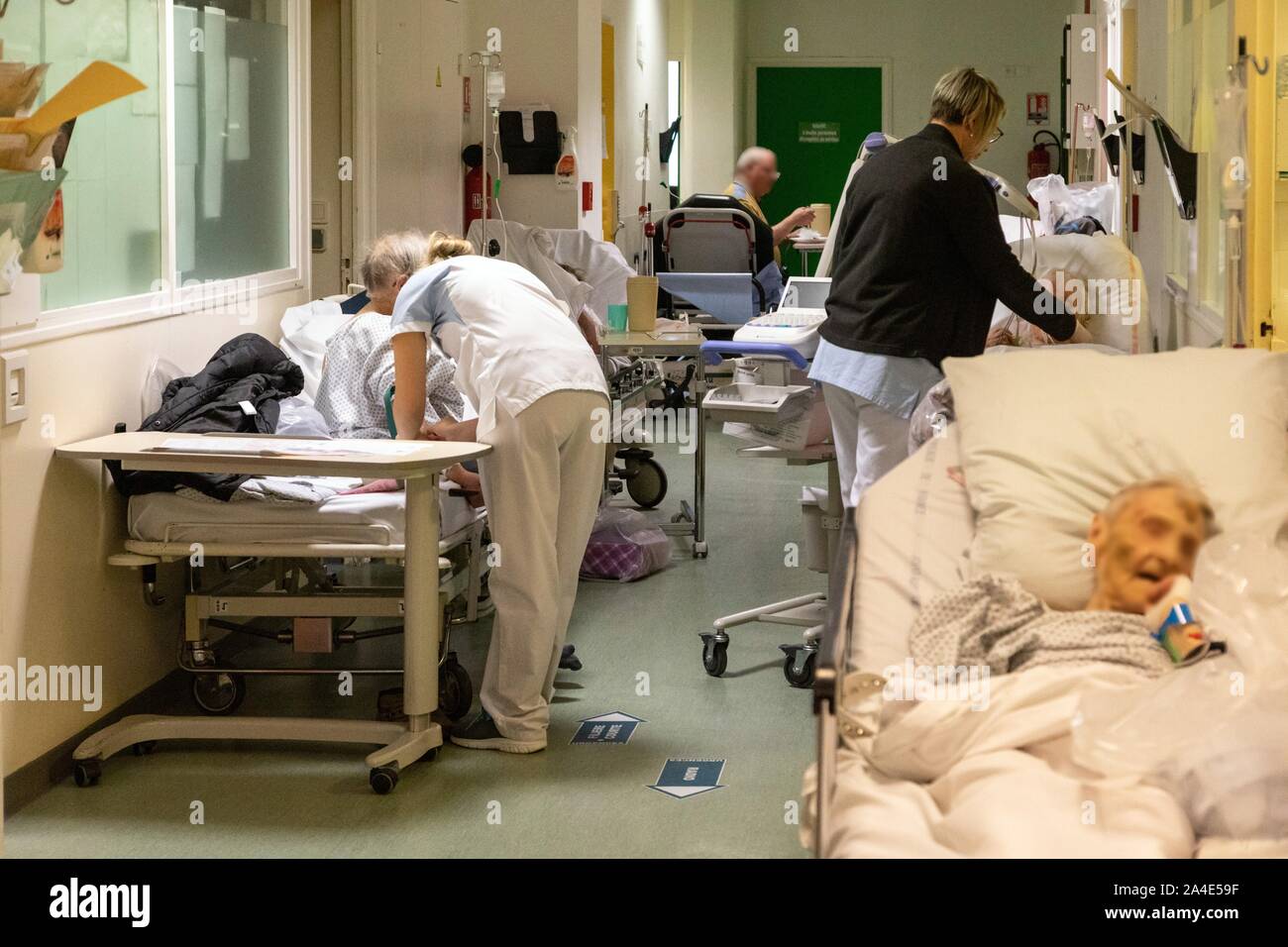 OVERLOAD AND CROWDING, PATIENTS WAIT IN THE CORRIDOR, EMERGENCY ROOM OF ...
