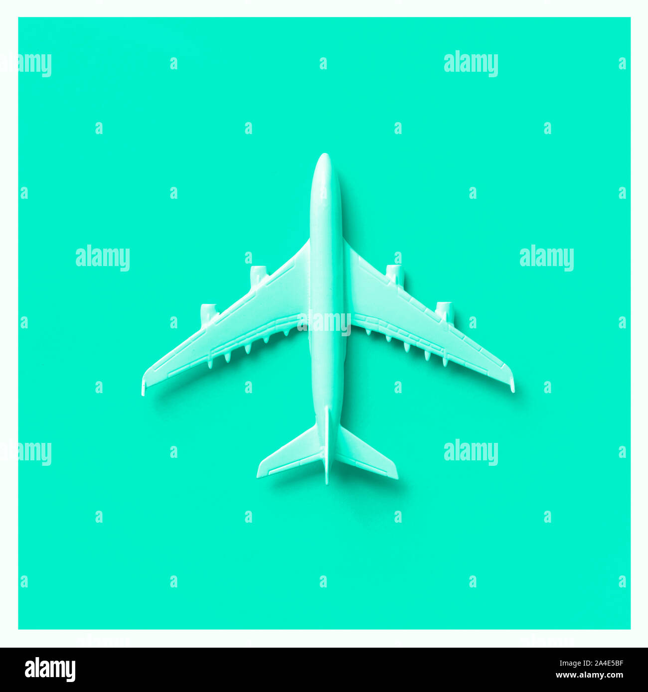 Travel, vacation concept. White model airplane on trendy green and ...