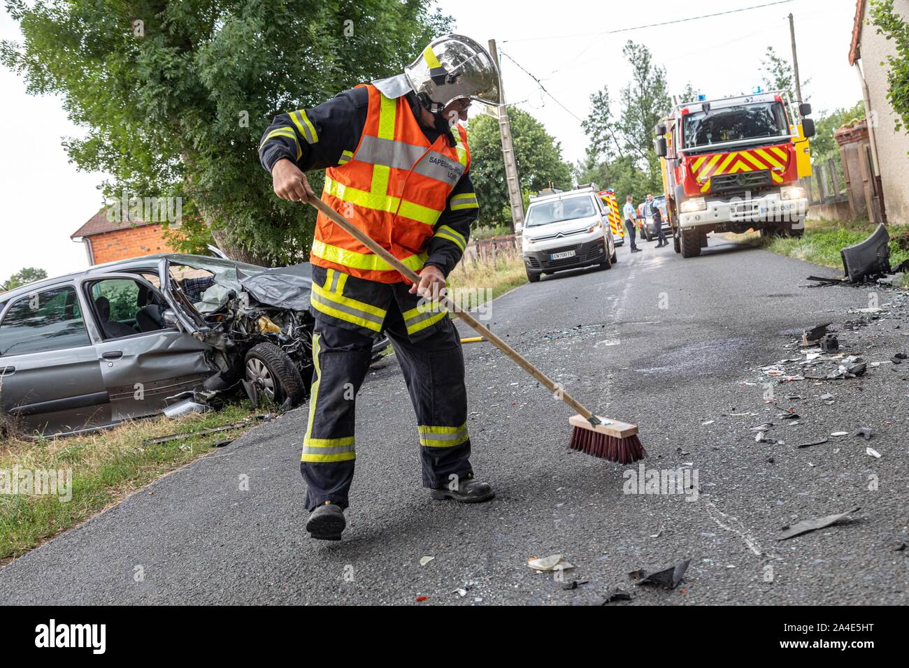 CLEANING THE DEBRIS FROM A CAR ON THE STREET FOLLOWING A ROAD ACCIDENT ...