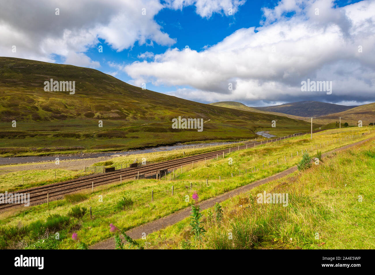 View of River Garry with train track and mountainous landscape ...