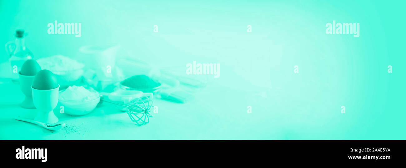 Healthy baking ingredients in mint color background. Trendy green and ...