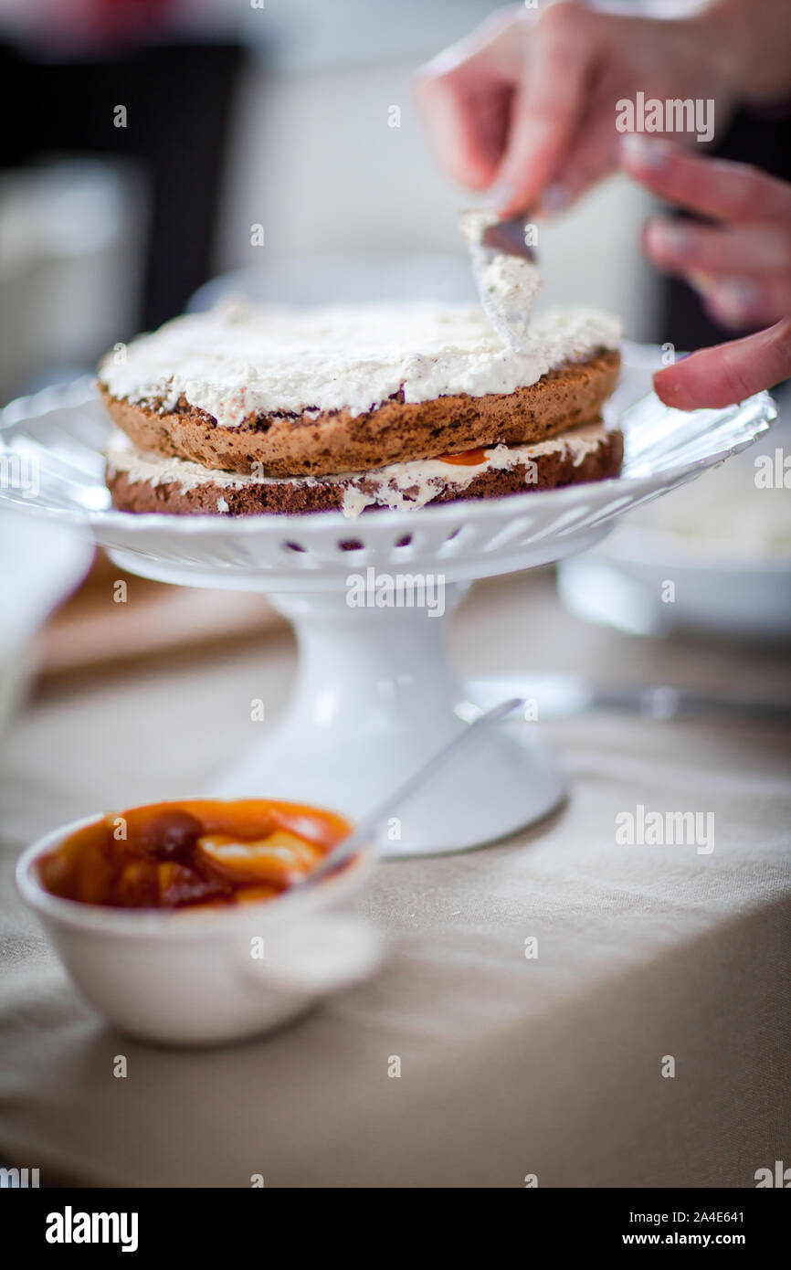 Creating a delicious multi-layered cake at home Stock Photo - Alamy