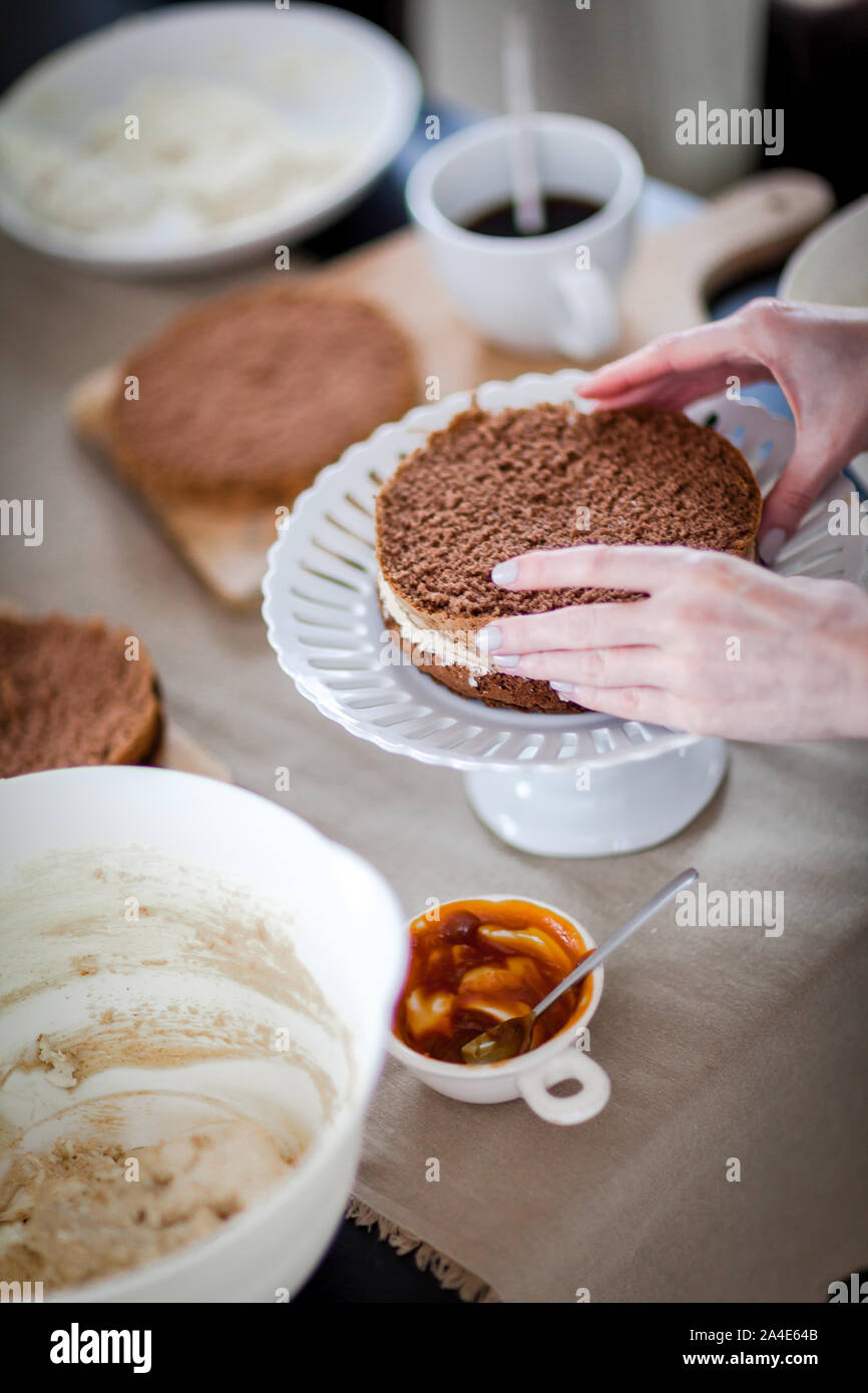 Creating a delicious multi-layered cake at home Stock Photo - Alamy