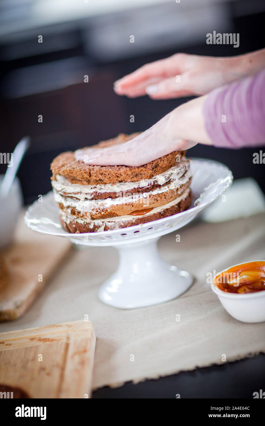 Creating a delicious multi-layered cake at home Stock Photo - Alamy