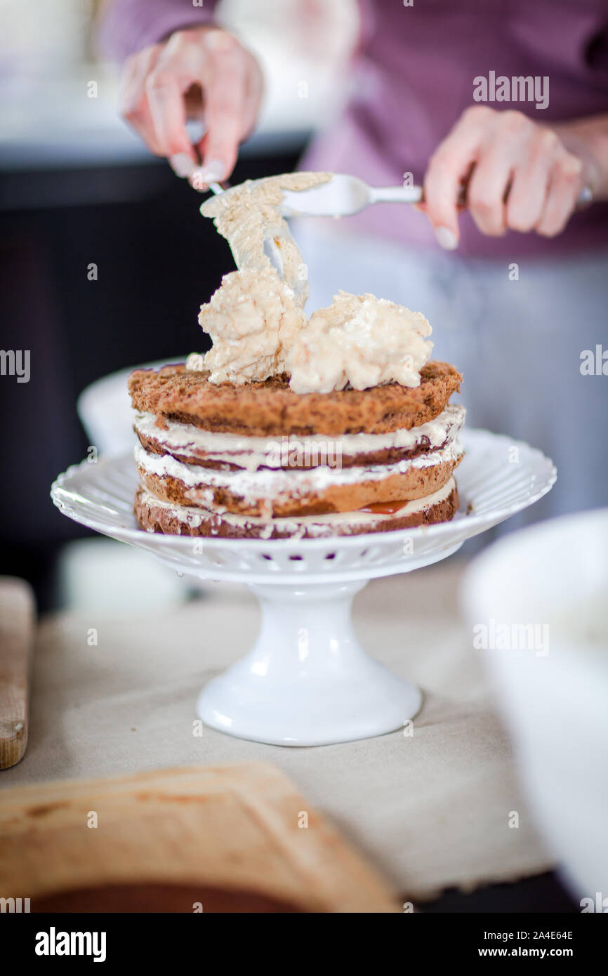 Creating a delicious multi-layered cake at home Stock Photo - Alamy
