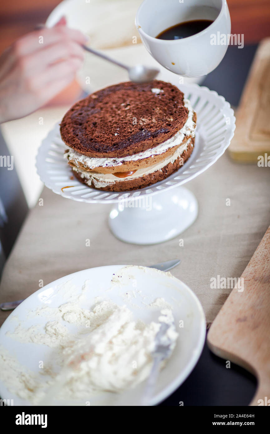 Creating a delicious multi-layered cake at home Stock Photo - Alamy