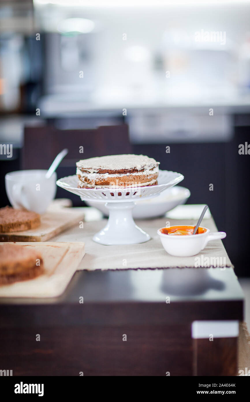 Creating a delicious multi-layered cake at home Stock Photo - Alamy