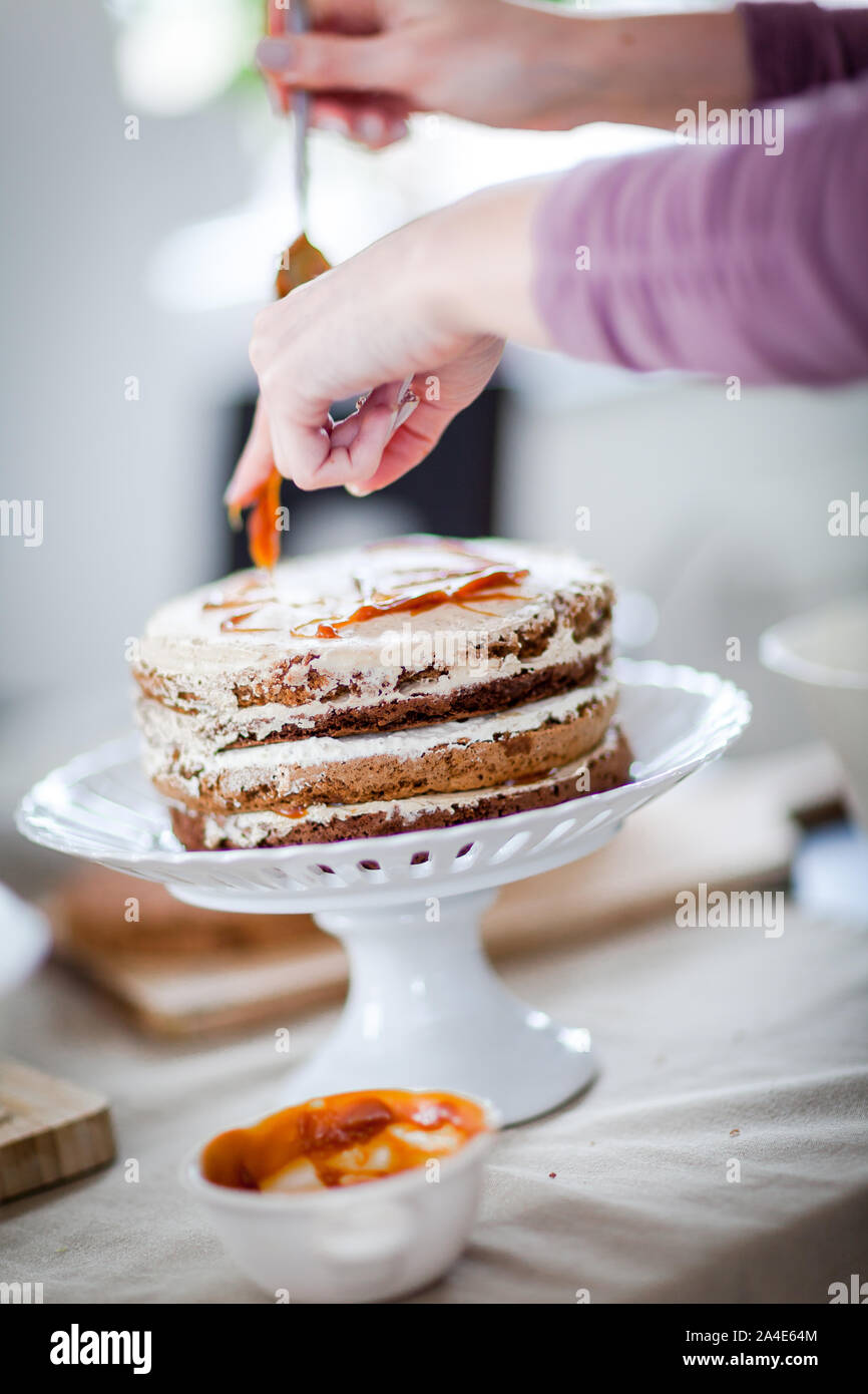 Creating a delicious multi-layered cake at home Stock Photo - Alamy