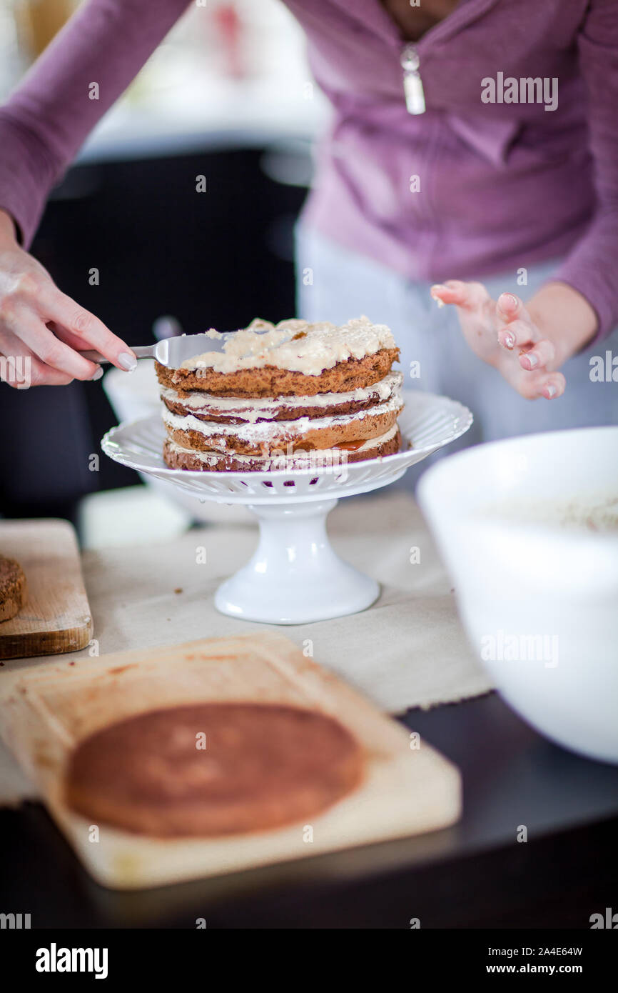 Creating a delicious multi-layered cake at home Stock Photo - Alamy