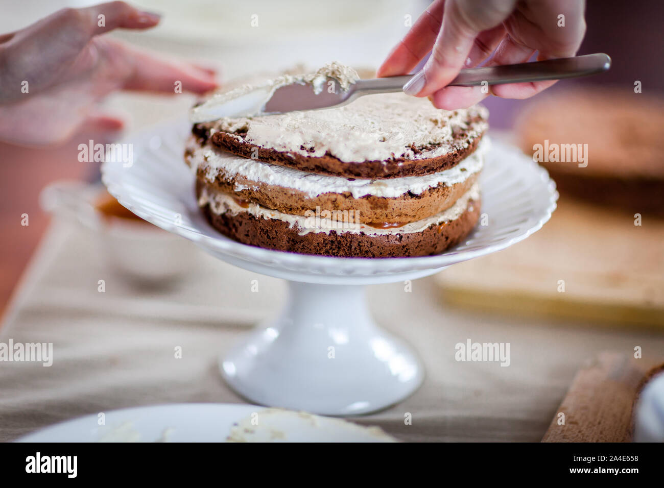 Creating a delicious multi-layered cake at home Stock Photo - Alamy