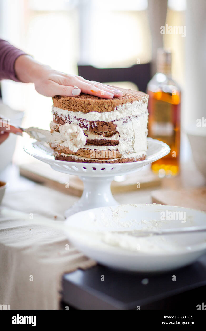 Creating a delicious multi-layered cake at home Stock Photo - Alamy
