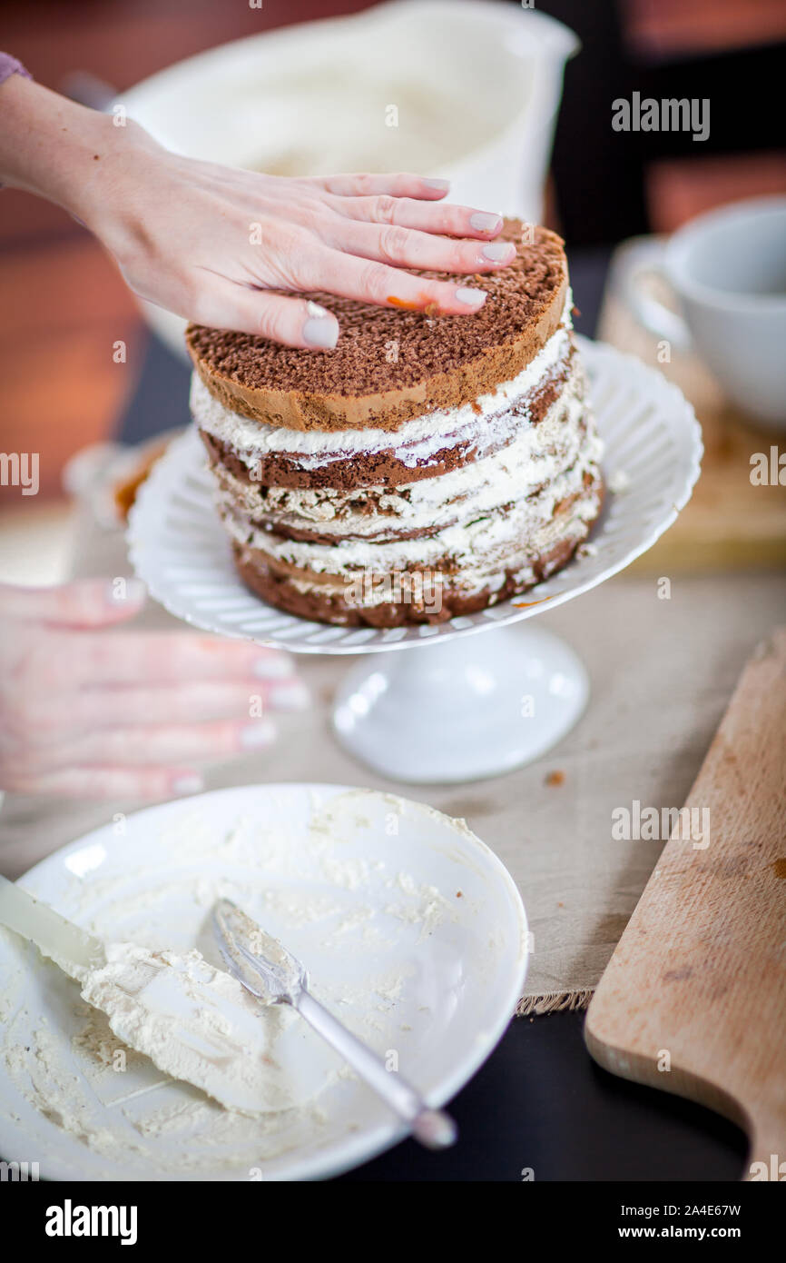 Creating a delicious multi-layered cake at home Stock Photo - Alamy