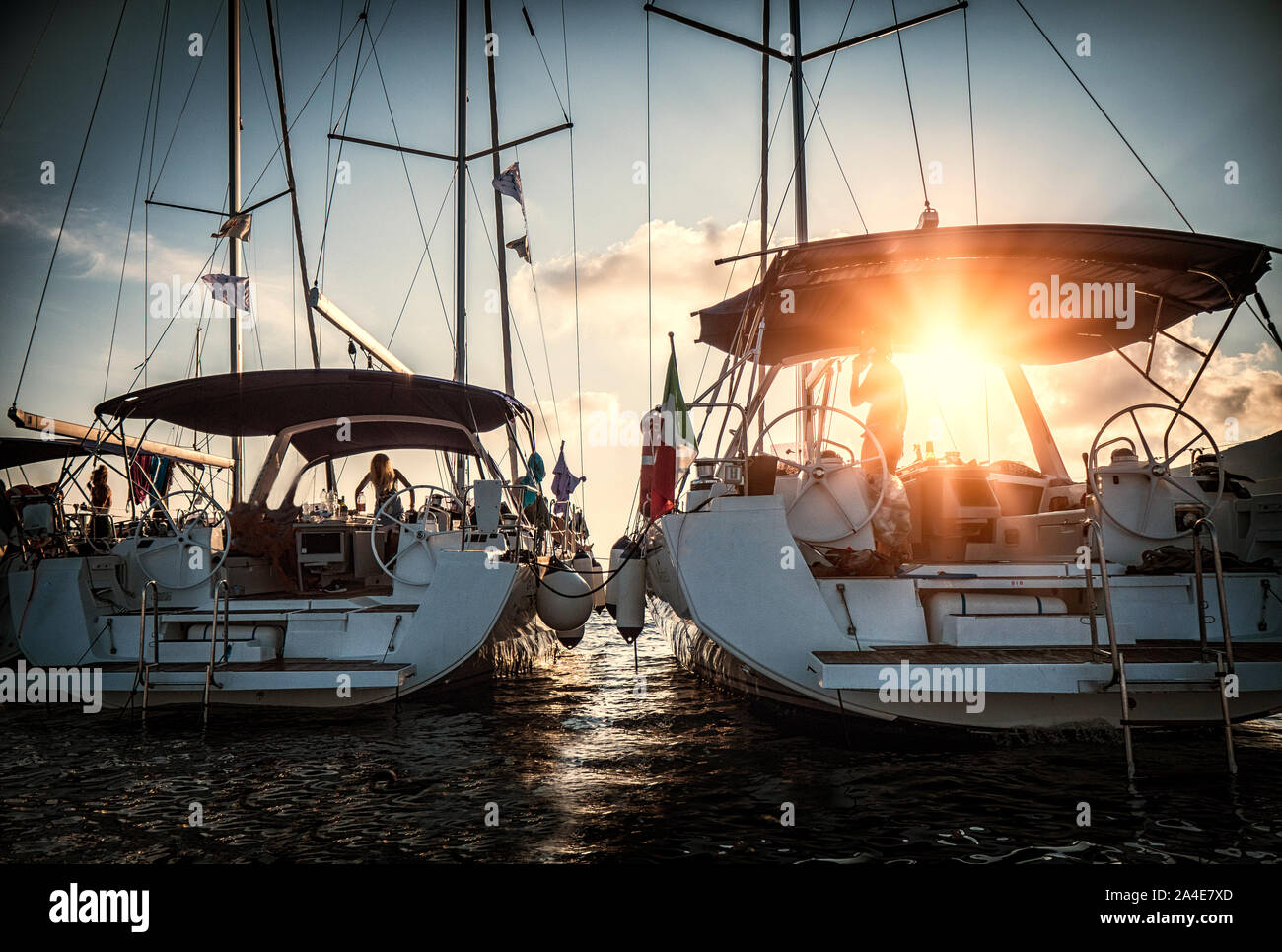 Modern yachts sailing in port in the evening Stock Photo - Alamy