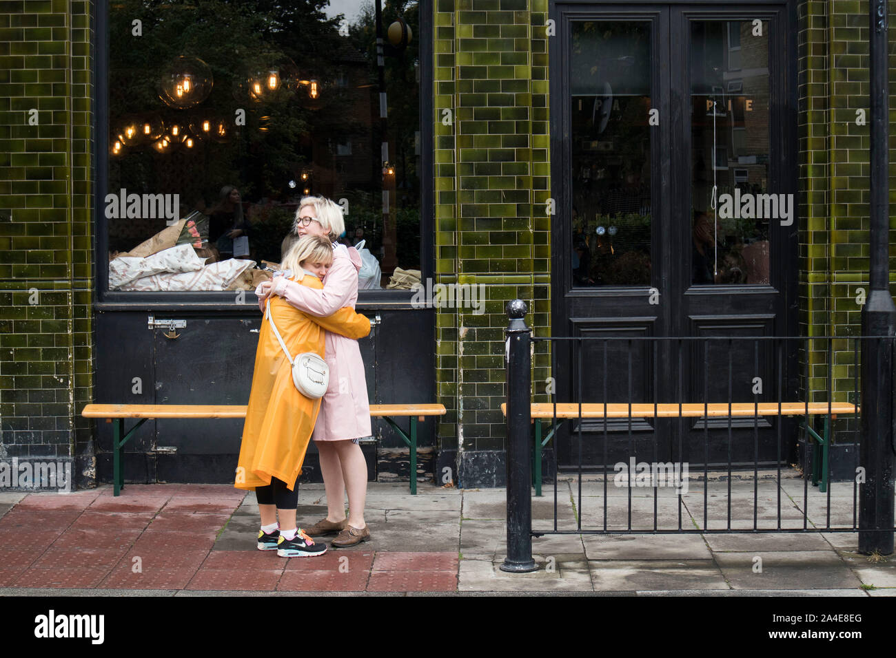 LONDON, ENGLAND - September 15, 2019 , Two girls hug while meeting in ...