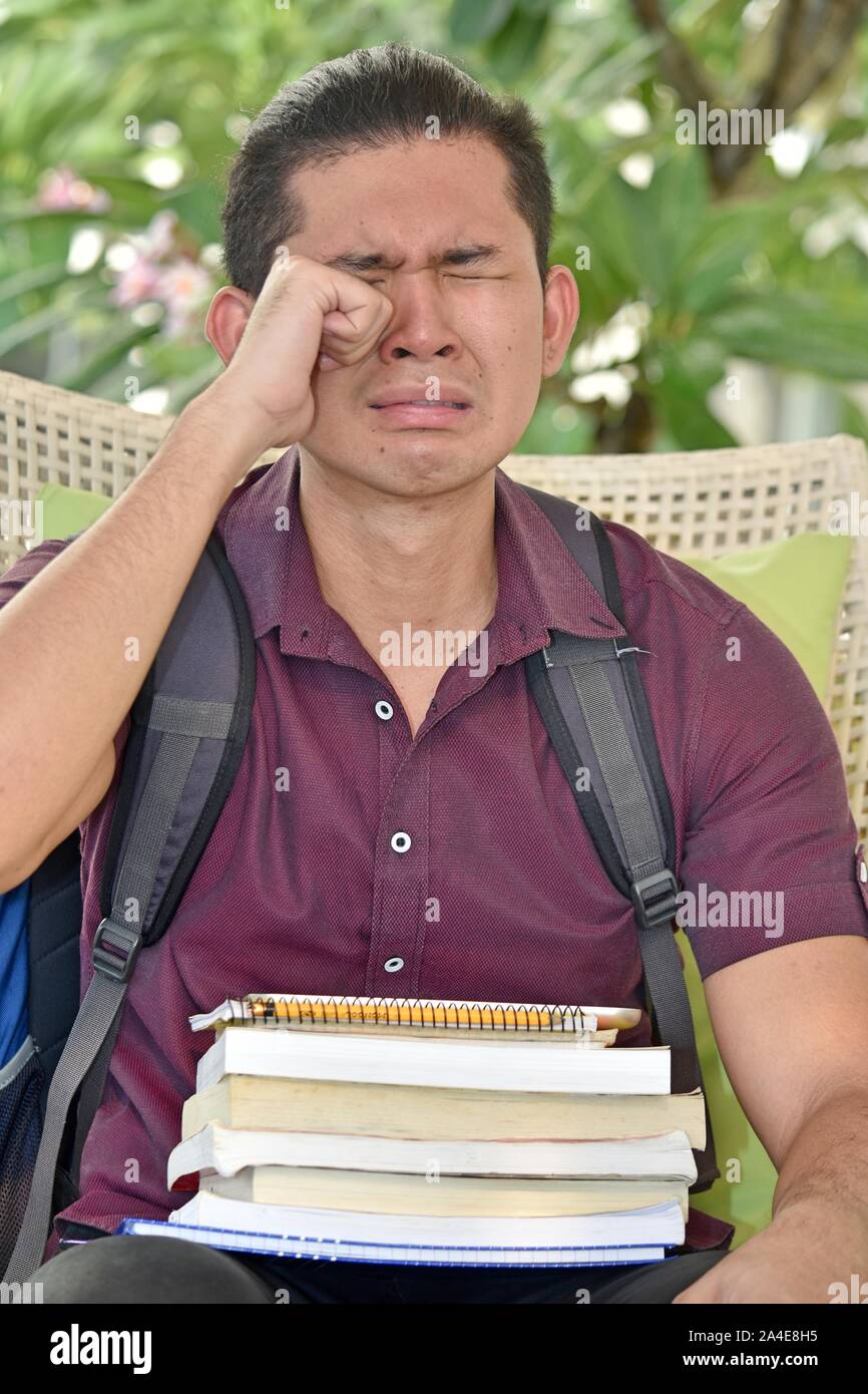 Tearful Handsome Asian Student With Notebooks Stock Photo - Alamy