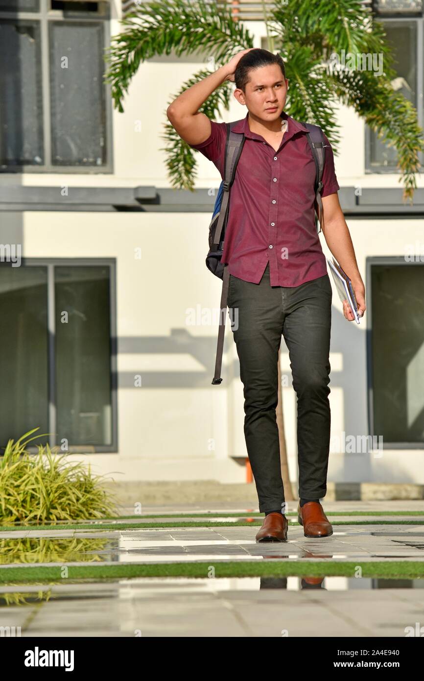 Confused Boy Student Walking On Campus Stock Photo - Alamy