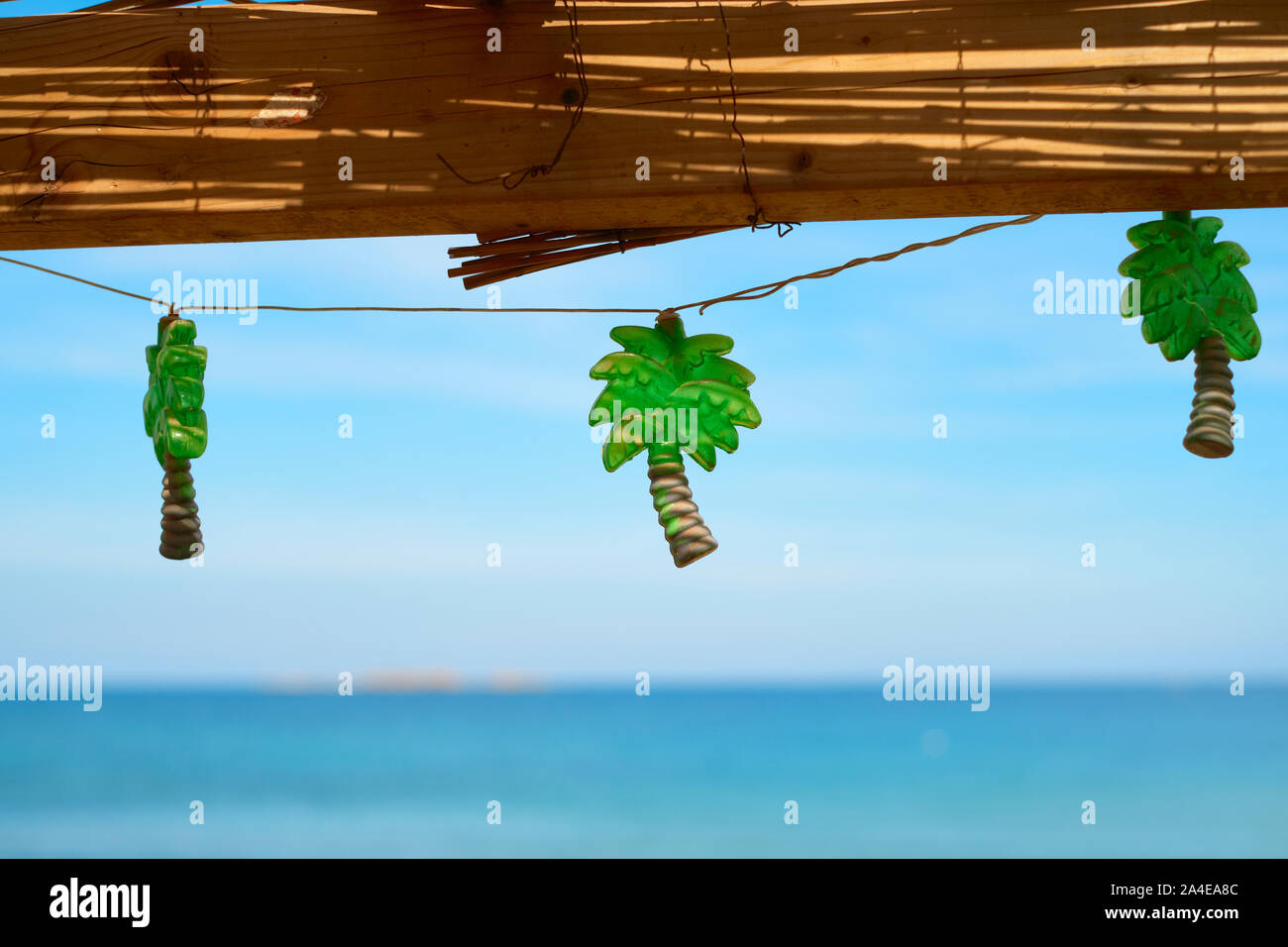 Palm tree shaped festive string lights decorating a rustic beach bar ...