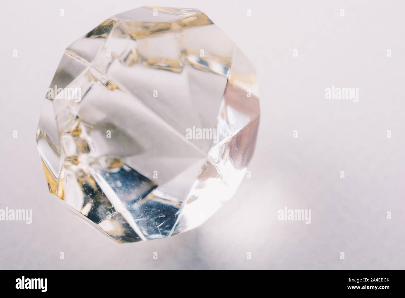 A transparent diamond on a white background on display Stock Photo - Alamy