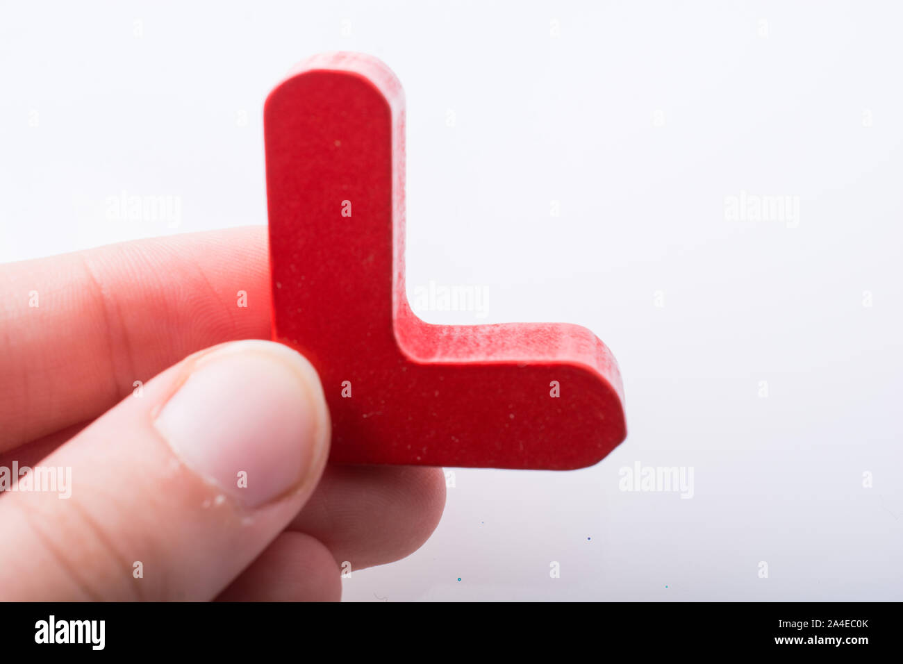 Hand holding letter cube L of made of wood Stock Photo - Alamy